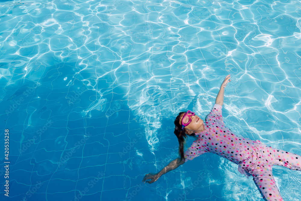 Girl in the swimming pool Stock Photo | Adobe Stock