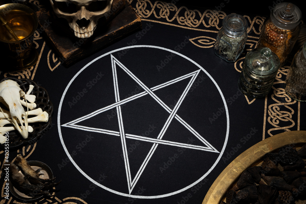 Huge pentagram symbol on the table. Mystic background with occult and ...