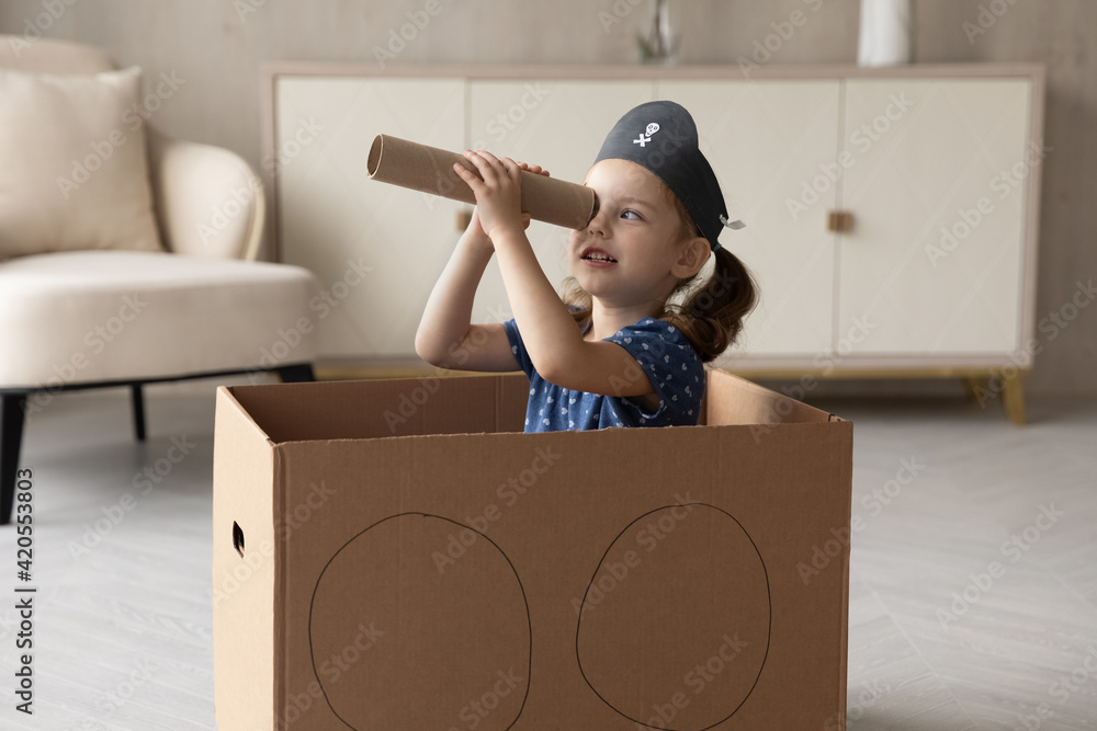 Cute little 7s Caucasian girl child in pirate hat look in spyglass have ...