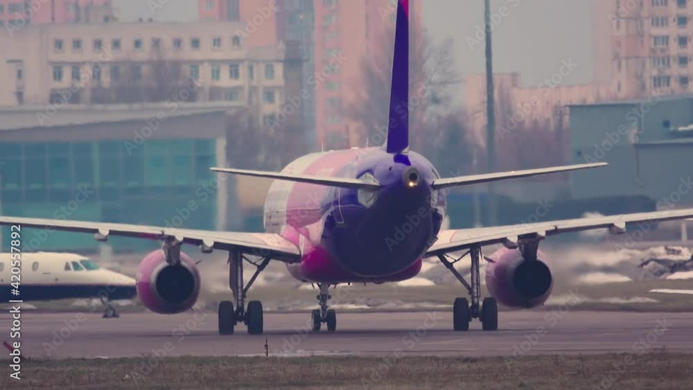 Airplane (aircraft) is taxiing on the taxiway to the airport terminal ...