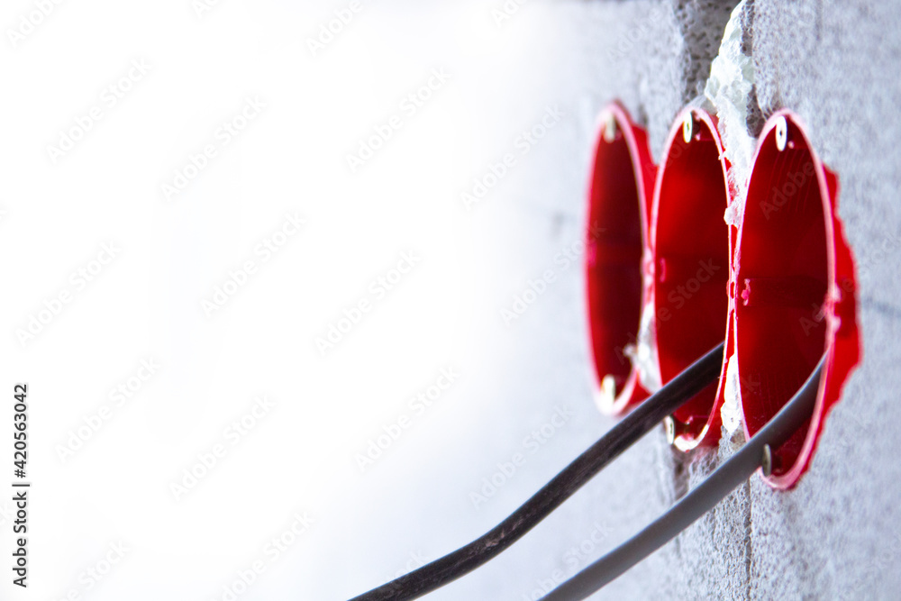 Socket boxes with wires in the wall. Cable routing background ...