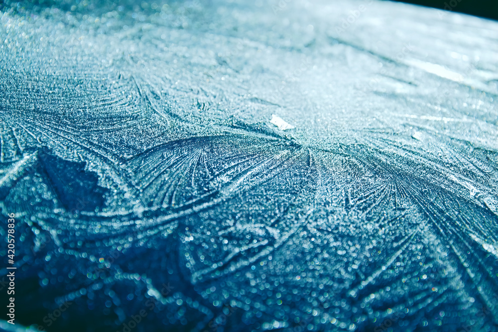 Artistic ice pattern on the hood of the car. Blue color grade of shapes ...