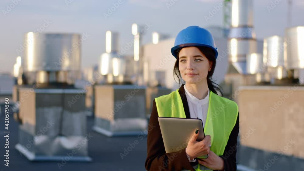 Construction assistant lady on the top of construction site using ...