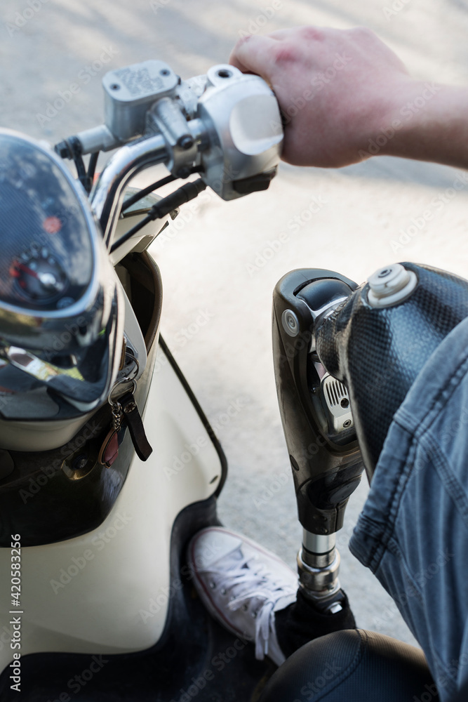 Motorbike driver having a prosthetic leg Stock Photo | Adobe Stock