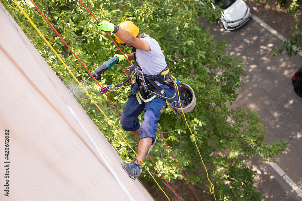 Working at elevations. Rope access, high-altitude outdoor work. Stock ...