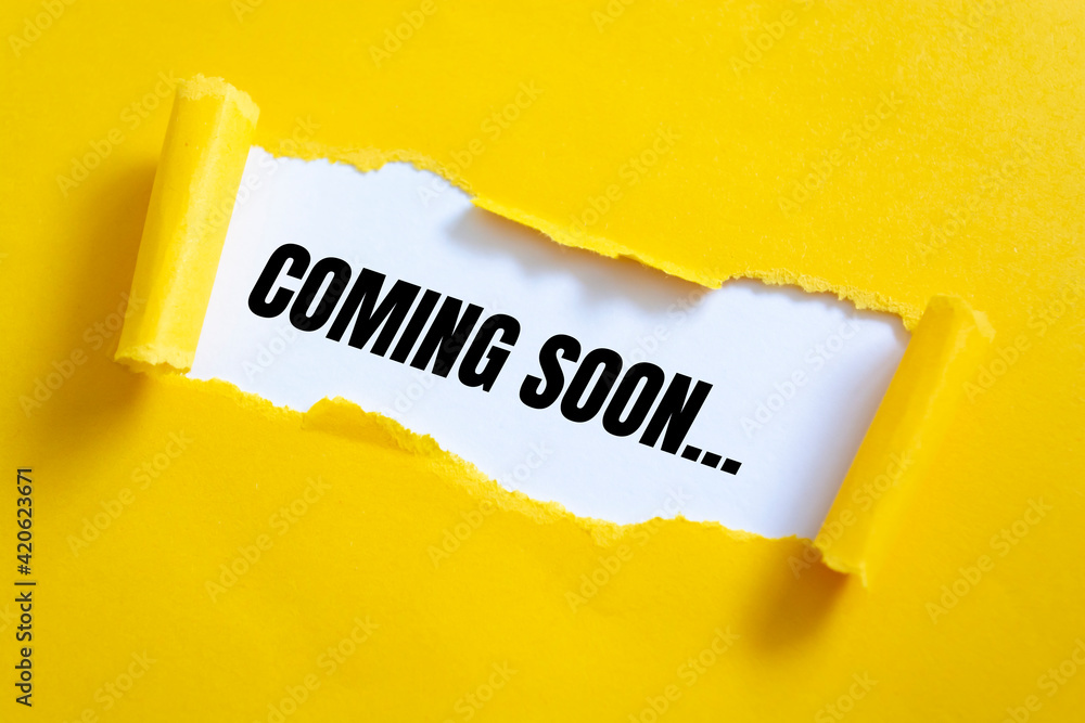 Text COMING SOON appearing behind torn yellow paper. For your design ...