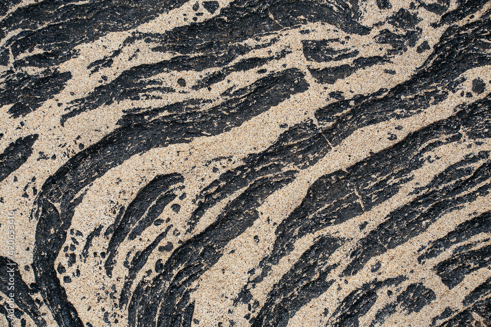 Lava flow partially covered by sand Stock Photo | Adobe Stock
