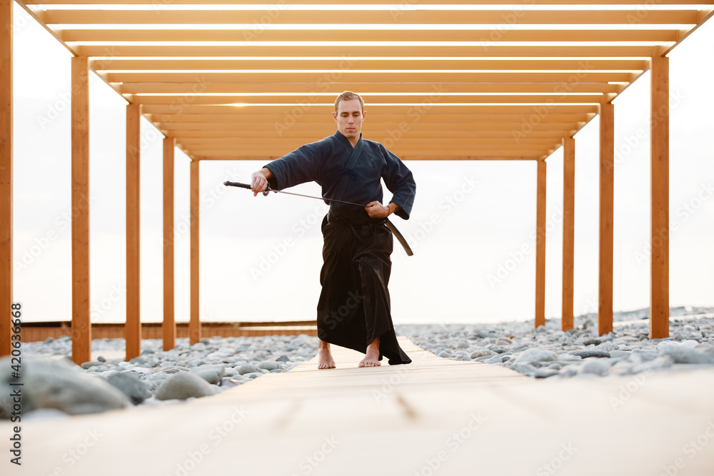 Barefoot samurai taking sword from scabbard Stock Photo | Adobe Stock