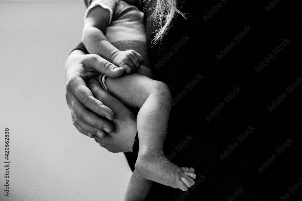 Faceless black and white image of mom holding baby Stock Photo | Adobe ...