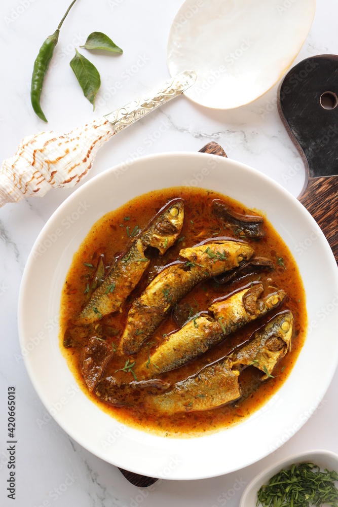 Indian fish curry. White Mullet fish curry made with dried mango and ...