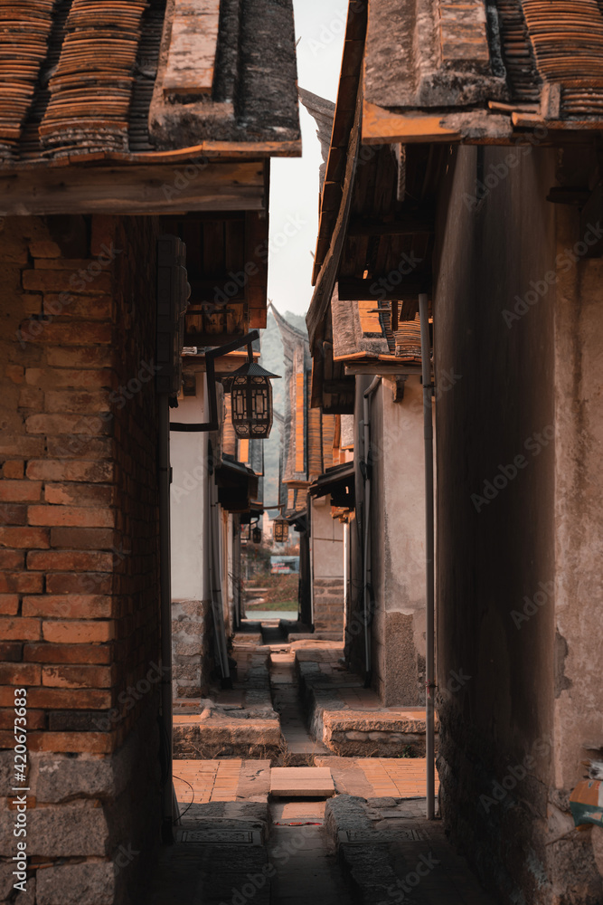 Narrow street among the ancient Chinese village buildings, an ...