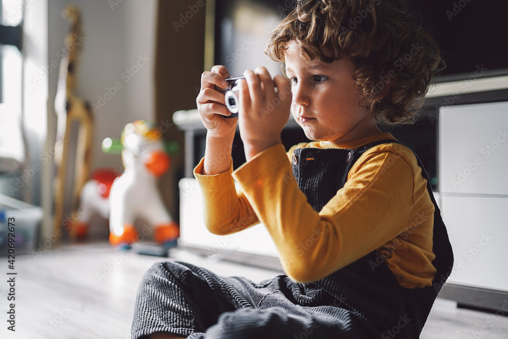 Boy playing with digital camera Stock Photo | Adobe Stock