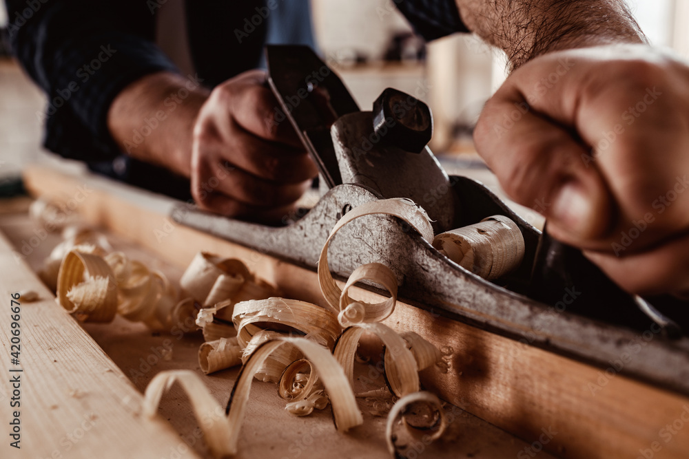 Carpenter's hands planing a plank of wood with a hand plane Stock Photo ...