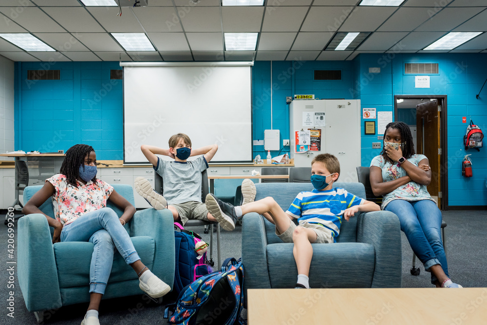 Students taking a break in a school classroom Stock Photo | Adobe Stock