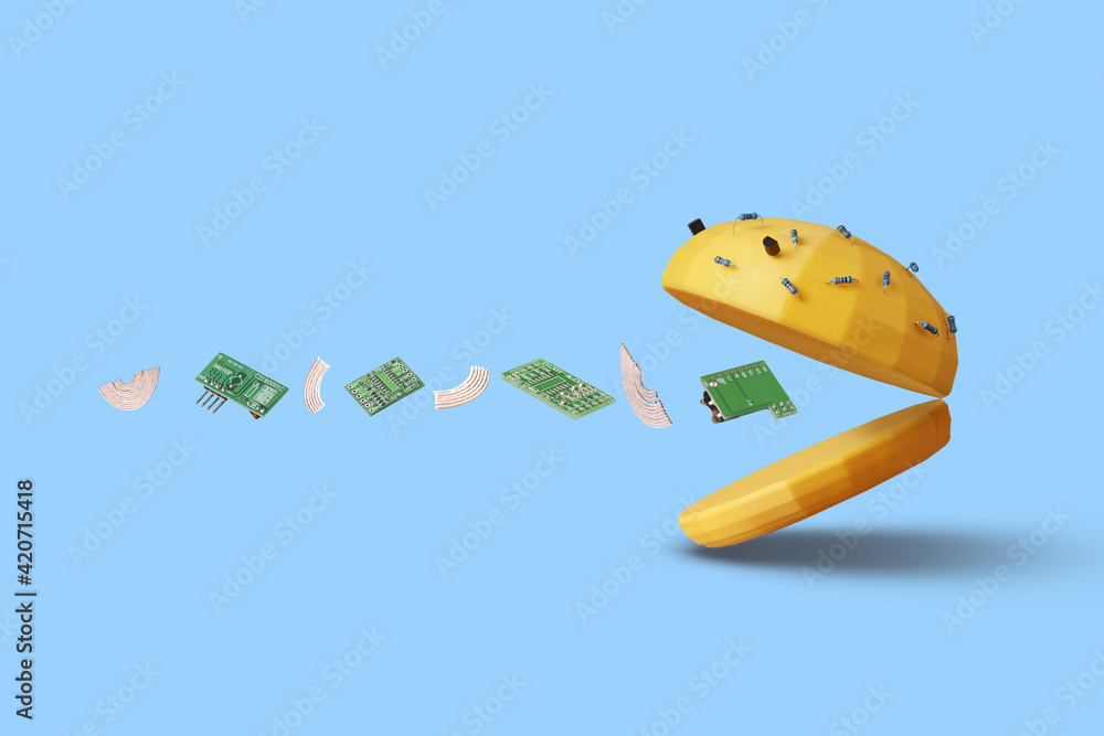 plastic burger eats boards of microcontrollers. Stock Photo | Adobe Stock