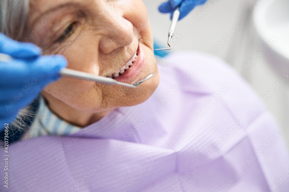 Assessment of old person teeth with dental devices Stock Photo | Adobe ...