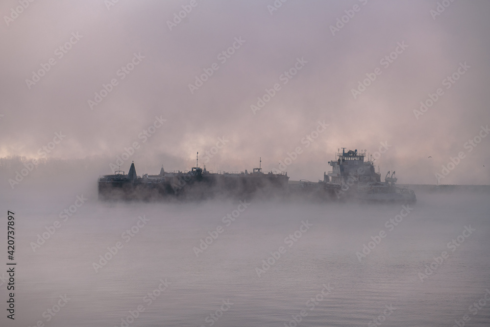 Empty cargo ships covered with fog in the shipyard Stock Photo | Adobe ...
