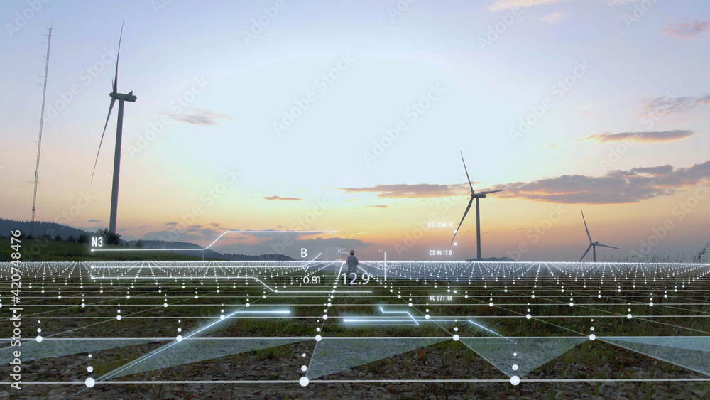 Futuristic engineer working on wind farm on sunset using nano ...