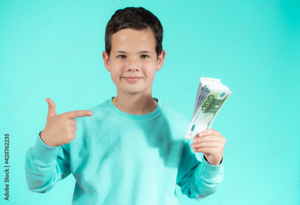 Surprised little boy with money cash. Cute kid hiding face behind fan ...