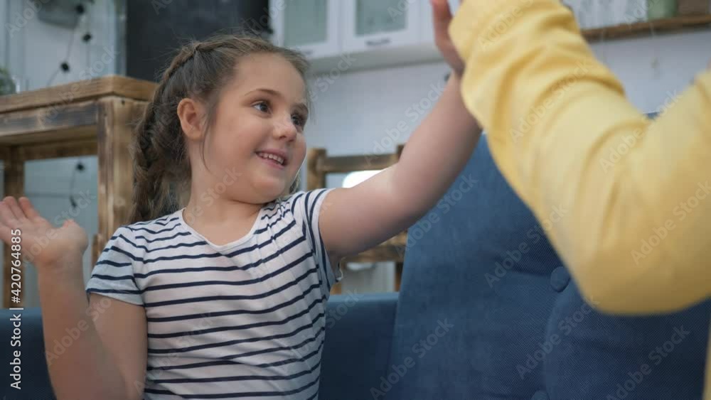 Happy family. Mom and daughter clap their hands. Lockdown coronavirus ...
