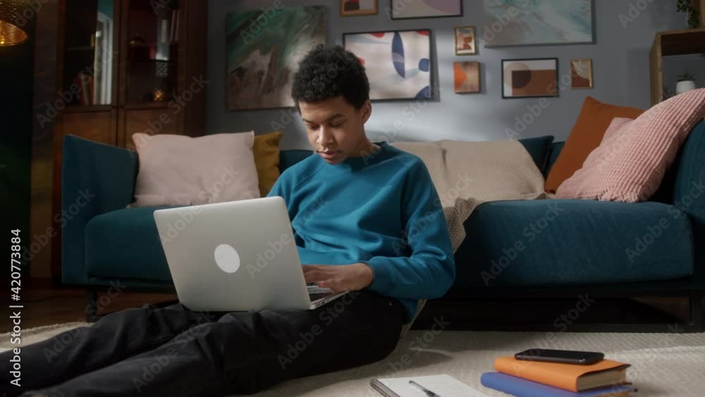 Black man teenager staying at home attending course online, learning ...