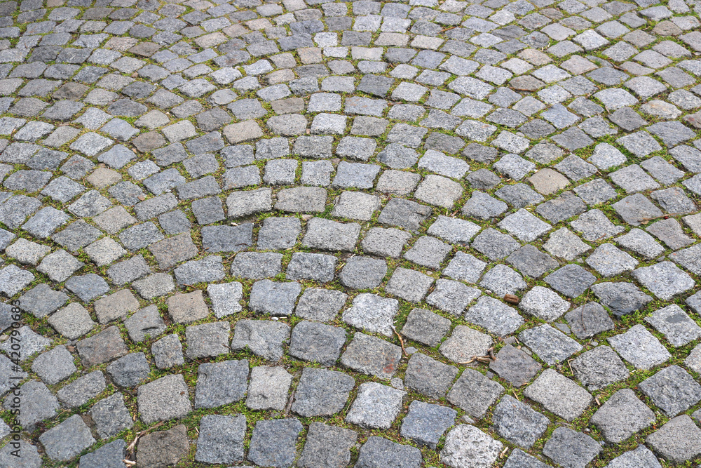 cobblestone with stone tiles in the floor of the street of an old town ...