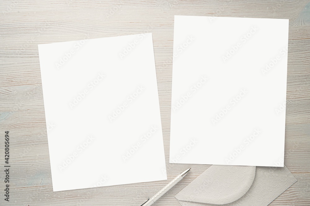 Stationery mockup, two empty writing paper sheets on white wooden ...
