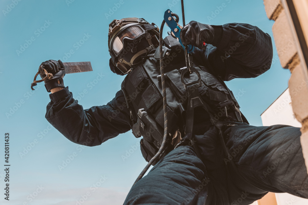 Special forces soldier storms the building through the window. Training ...