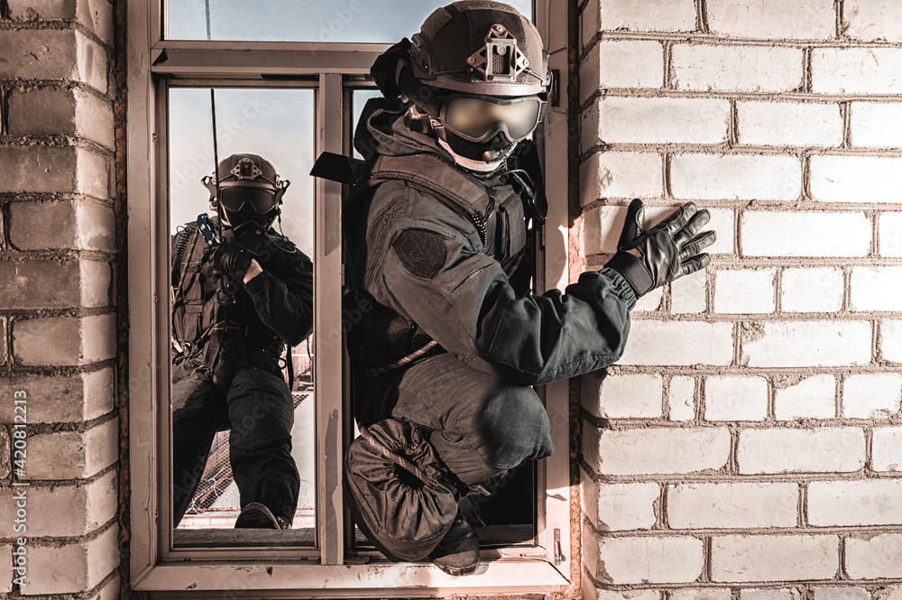 Group of special forces fighters storm the building through the window ...