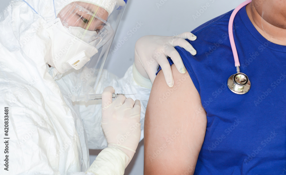 Doctor or nurse wearing ppe suit, mask, face shield, gloves are ...