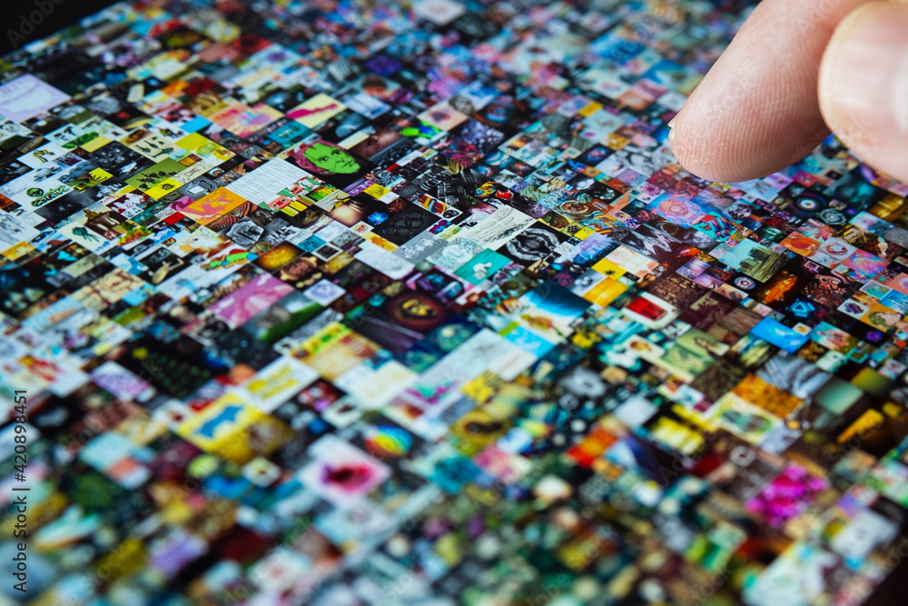 Foto de Finger pointing at tablet screen with Beeple pattern ...