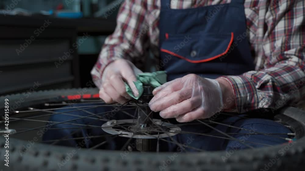 Technical expertise taking care bicycle shop. Handsome young mechanic ...
