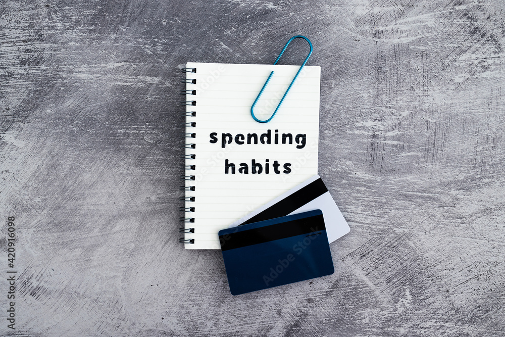 spending habits text on notepad with payment cards next to it, money ...