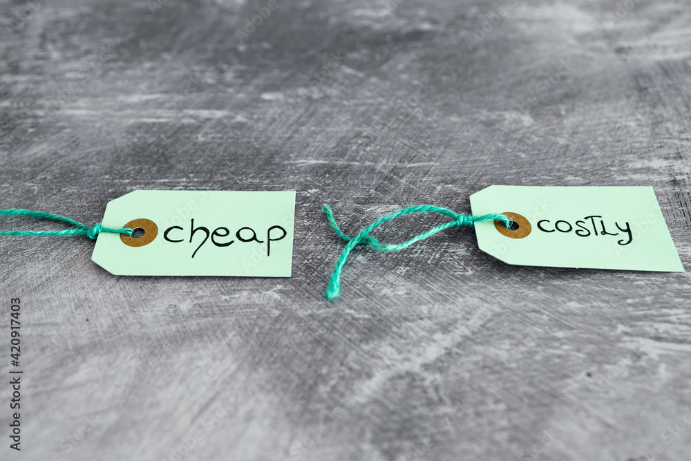 Cheap vs Costly prioduct price tags next to each other symbol of options for the customer, money ...