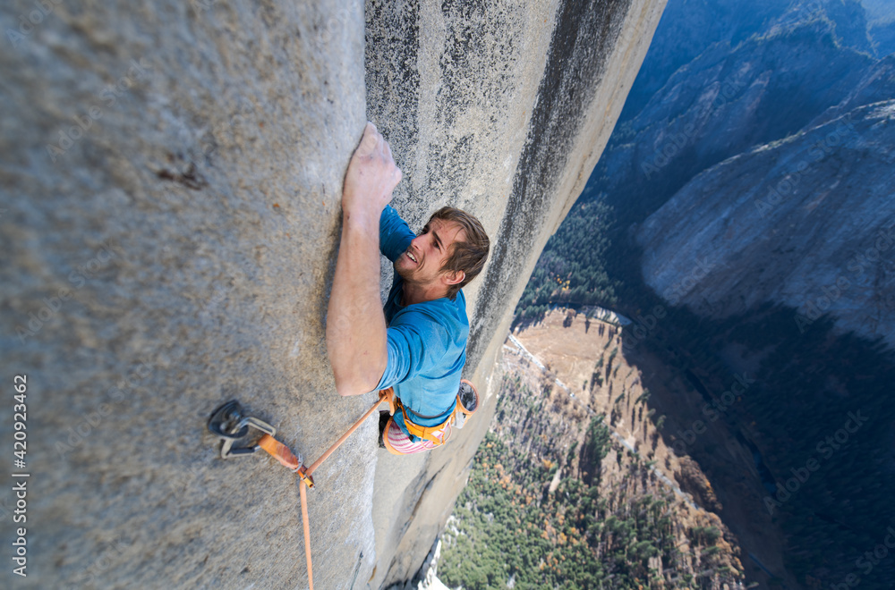 High angle view of mountaineer climbing up sheer wall of The Nose, El ...