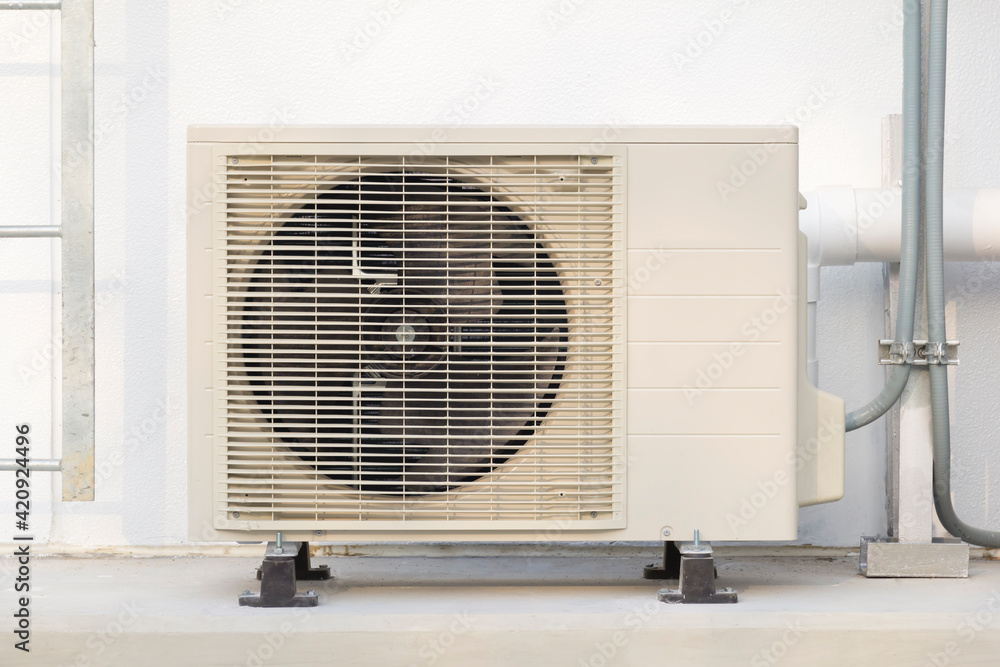 Condenser unit or compressor outside home or residential building. Unit ...