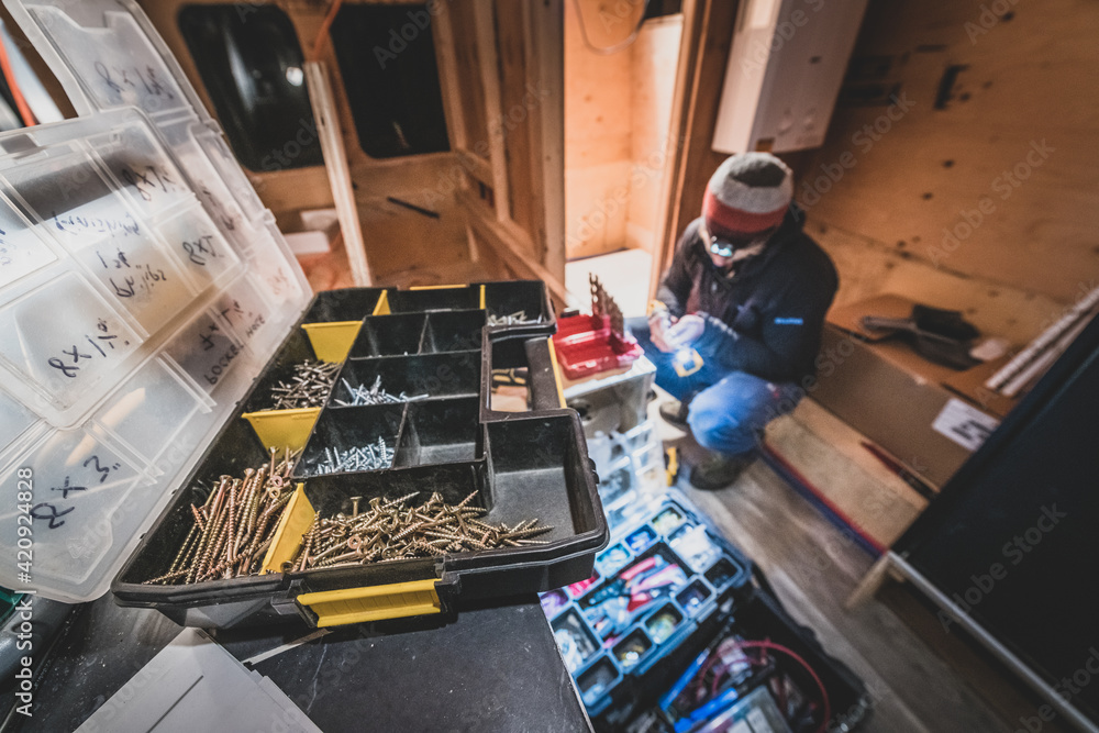 Man with toolbox kneeling in a kitchen, doing DIY. Stock Photo | Adobe ...