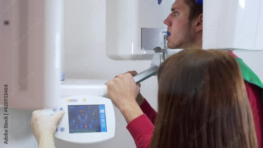 Modern dental X-Ray scanner makes a panoramic radiograph of the jaw of ...