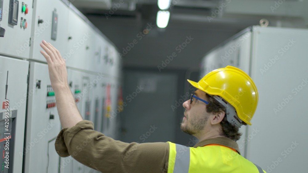 Electric engineer hold tablet for monitoring electrical system in ...
