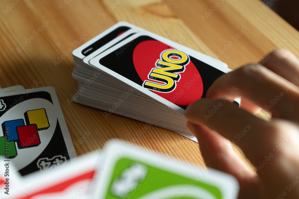 Bangkok, Thailand - January 23, 2021 : A man playing UNO card game ...