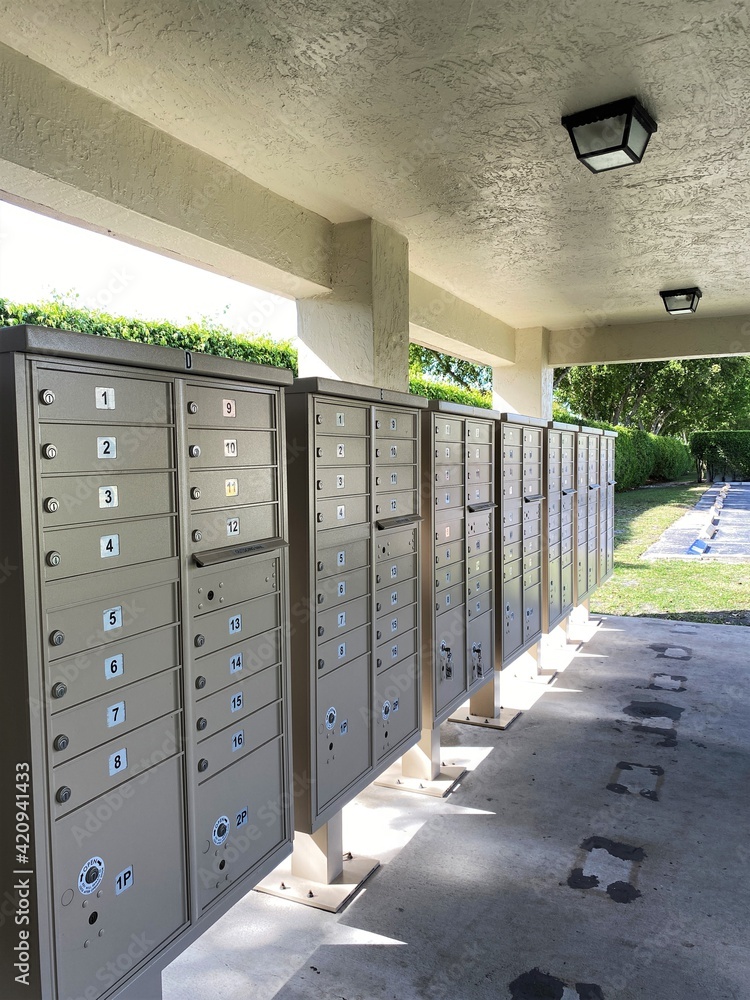 Cluster of residential mailboxes with numbered compartments for a ...