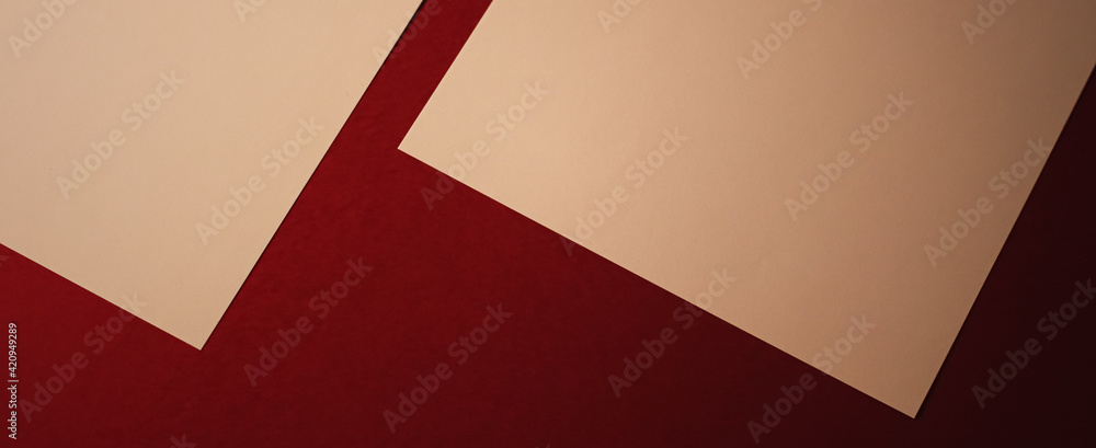 Beige A4 papers on dark red background as office stationery flatlay ...