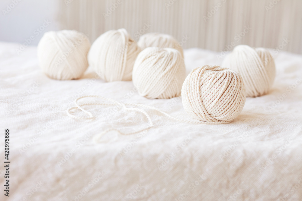 Handmade macrame braiding and cotton threads on white background. Light ...