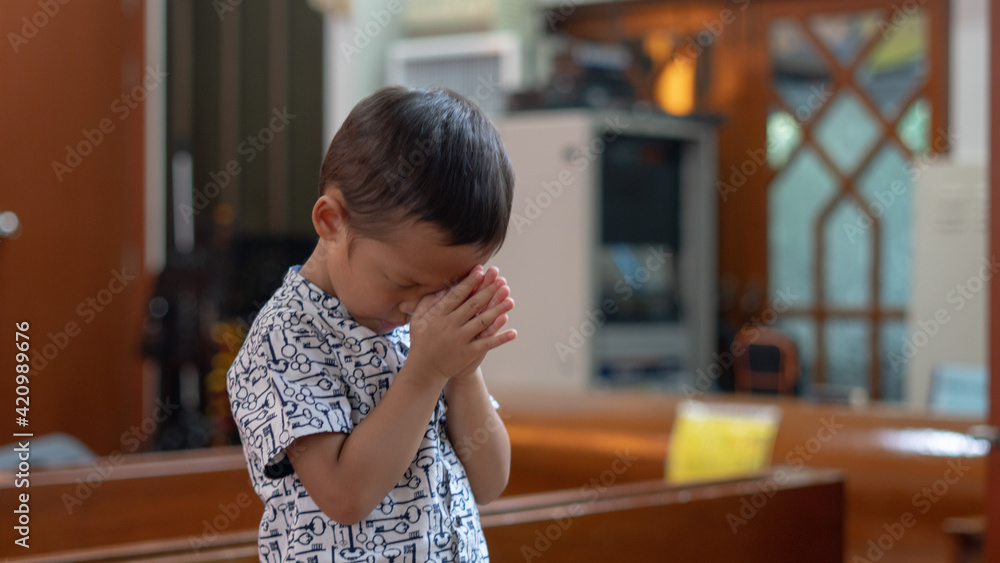 Little Christian Asian Boy Praying to God In worship room at church ...