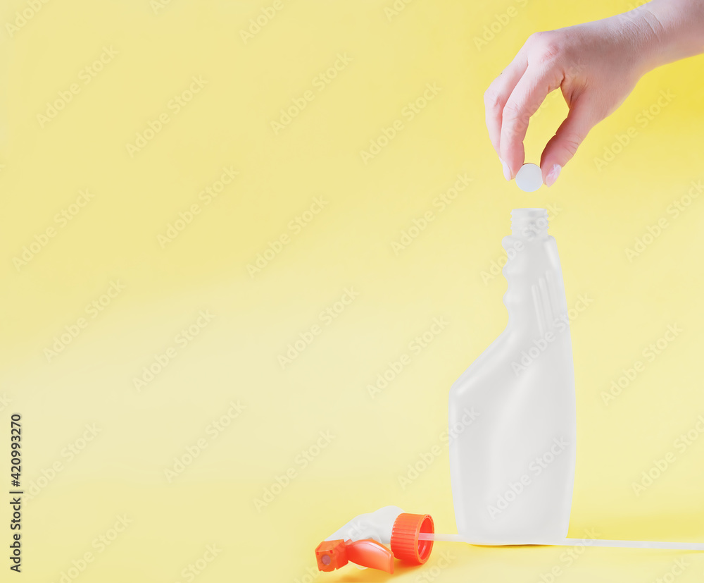 female hand holding refill tablet for cleansing detergent. home ...