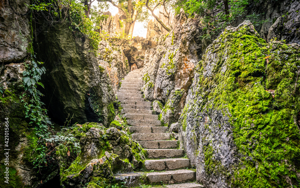 Stairs pathway in middle of limestone rock formation and dramatic light ...