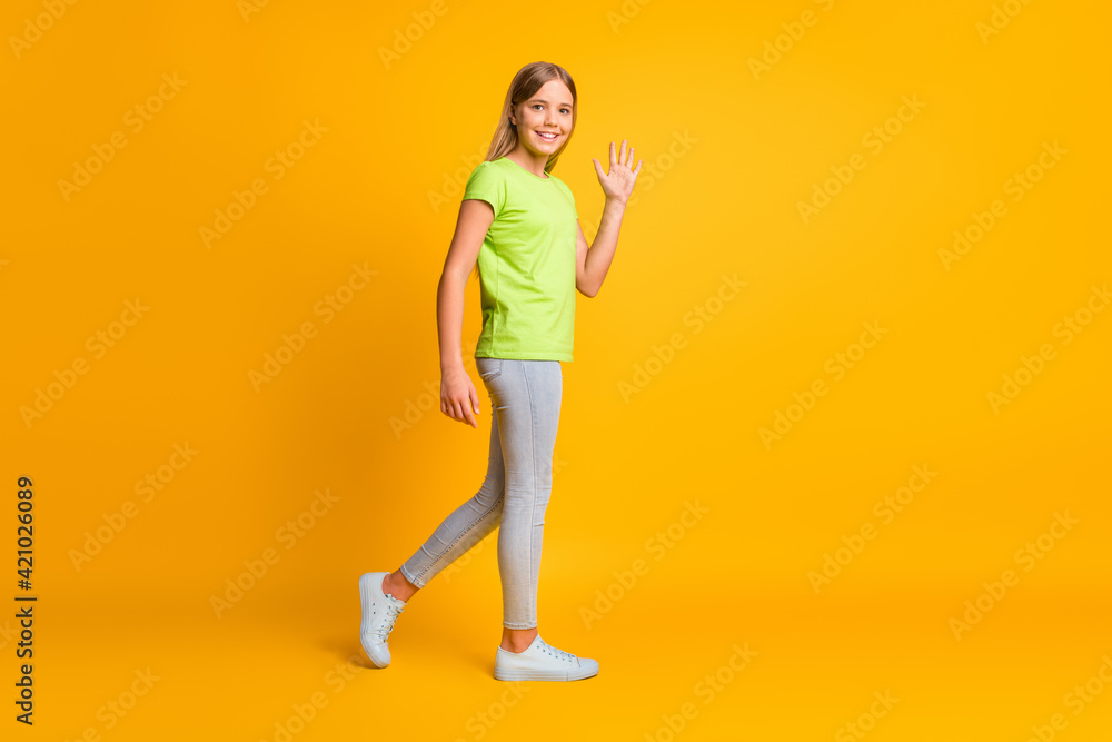 Full length profile side photo of young girl happy smile wave hand hi ...