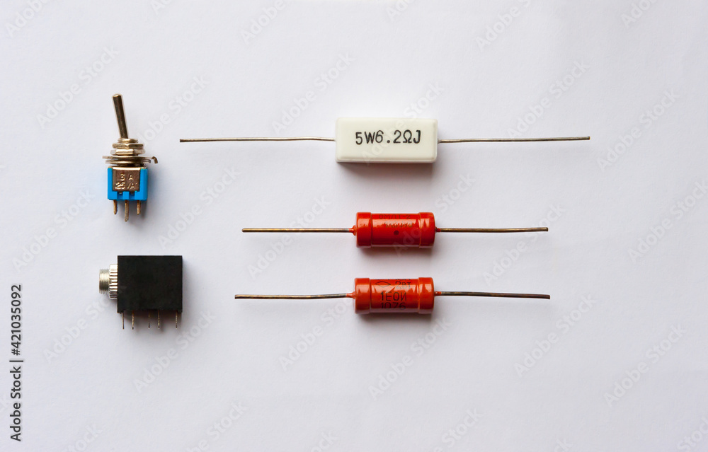 Radio components on a white background - powerful resistors, a toggle ...
