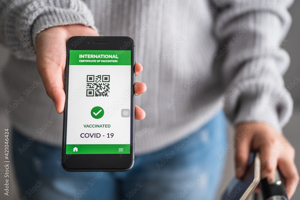 Tourist women show app mobile on smartphone vaccinated COVID-19 or ...