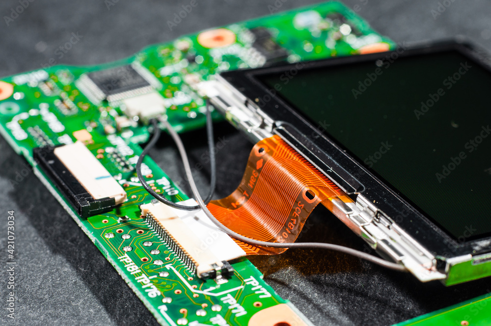 Green electronic board with a connected monitor through a flat ribbon ...